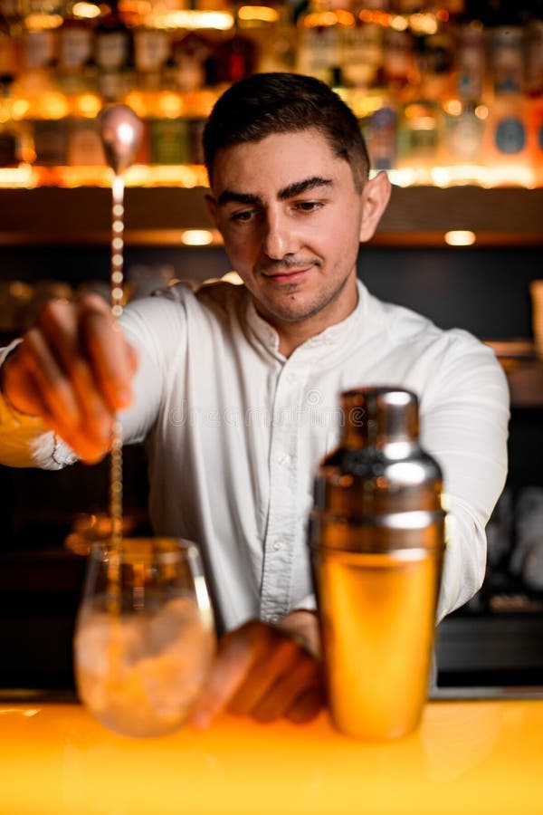 Selective Focus of Bartender Stirring Alcoholic Cocktail with Bar Spoon ...