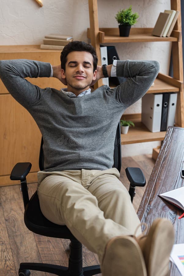 Selective Focus of Businessman with Hands Behind Head Put Legs on Table ...