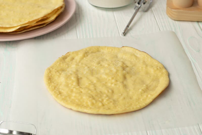 Cake Layers on Baking Parchment. the Base of the Cake on a Wooden Table ...