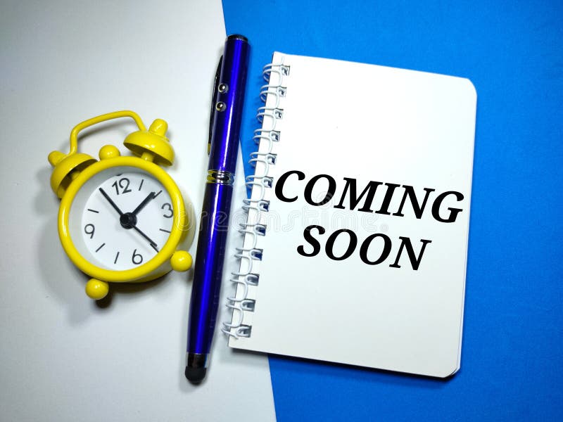 Selective Focus.Clock,pen and Word COMING SOON on a Notebook with Blue ...