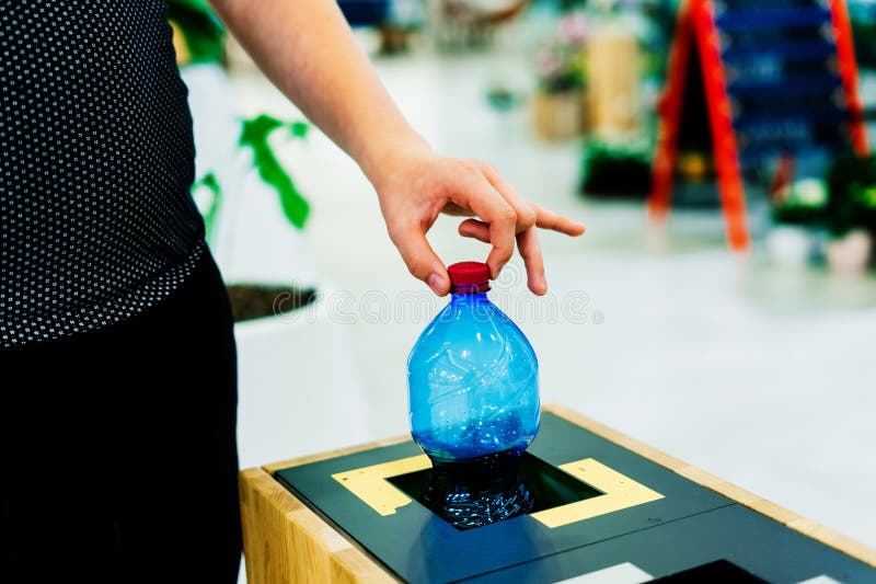Selective Focus Close Up Hand Throwing an Empty Plastic Bottle in the ...