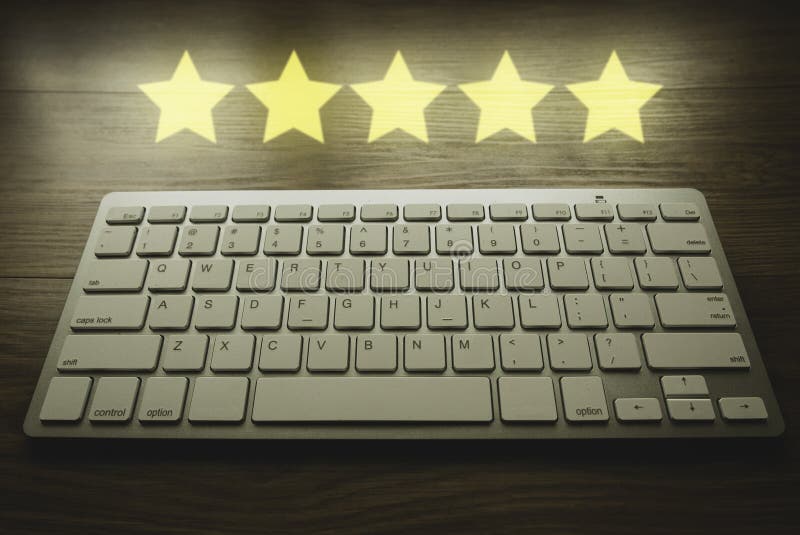 Selective Focus of Computer Keyboard and a Glow Gold Five Star Rating ...
