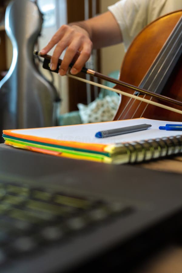Selective Focus of a Computer a Spiral Notebook and a Young Man Playing ...