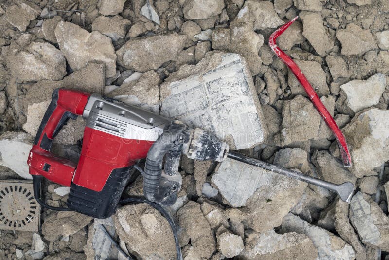 The Crowbar and Jackhammer Lies on Large Pieces of Broken Cement Walls ...