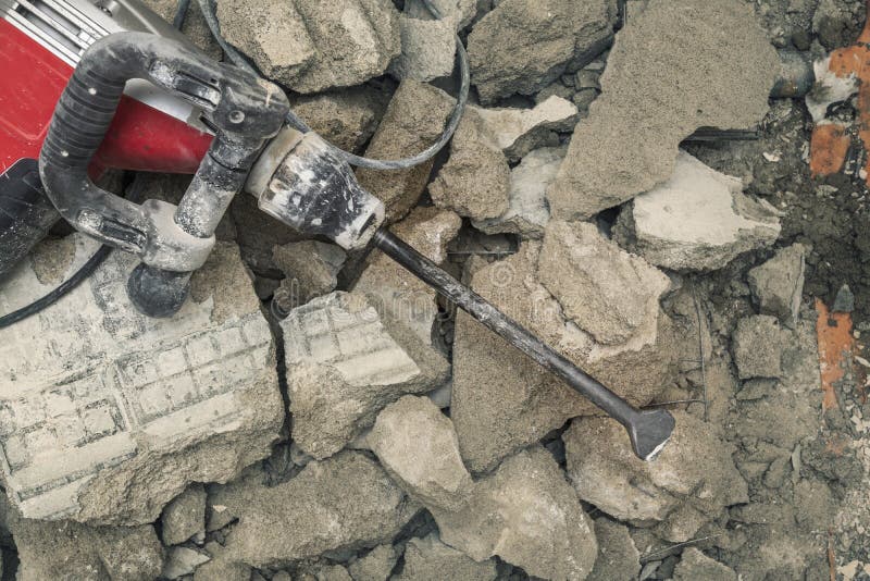 The Crowbar and Jackhammer Lies on Large Pieces of Broken Cement Walls ...