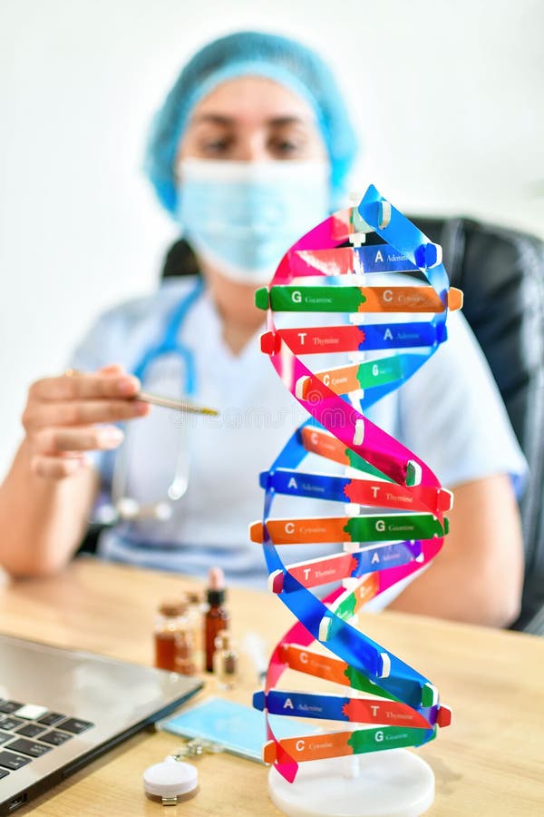 Selective Focus of a Doctor and a DNA Model Structure Near Laptop on ...