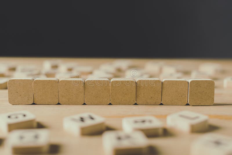 Focus of Eight Empty Cubes Surrounded by Blocks with Letters on Wooden ...
