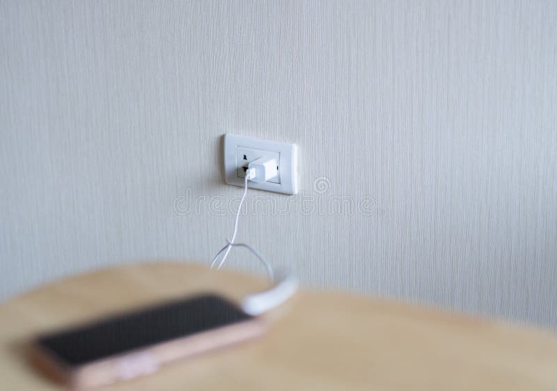 Selective Focus. Electric Socket with Connected Phone Charger Stock ...