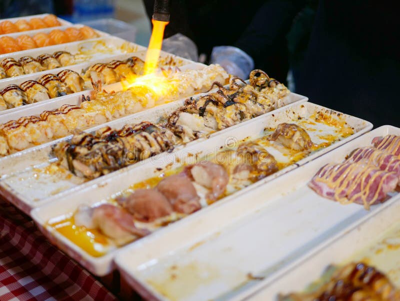 Selective Focus of Fire from a Fire Gun on Cooking Sushi Stock Image ...