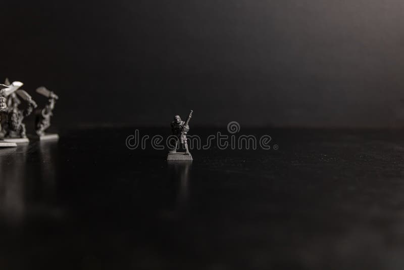 Selective Focus Grayscale Shot of a Soldier Holding a Gun Figurine ...