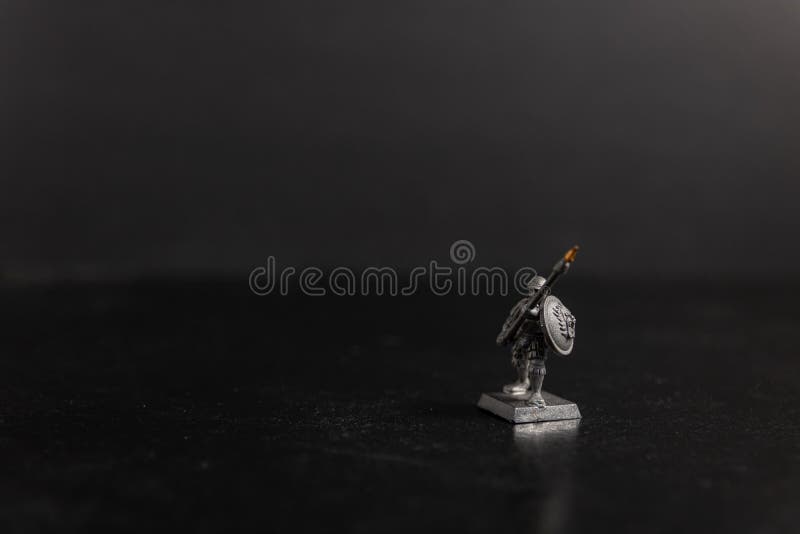 Selective Focus Grayscale Shot of a Spartan Holding a Spear Figurine ...