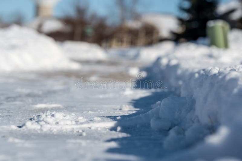 Selective Focus Ground Level View of Snow Blown Sidewalk Section with ...