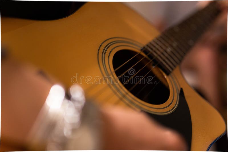 Selective Focus of Guitar Strings. Woman Playing the Guitar at Home ...