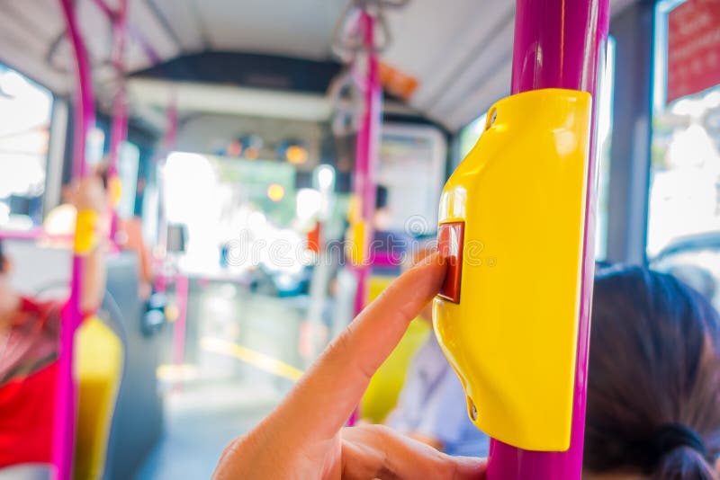 Selective Focus of a Hand Pushing a Bus Stop Button Inside of the Bus ...