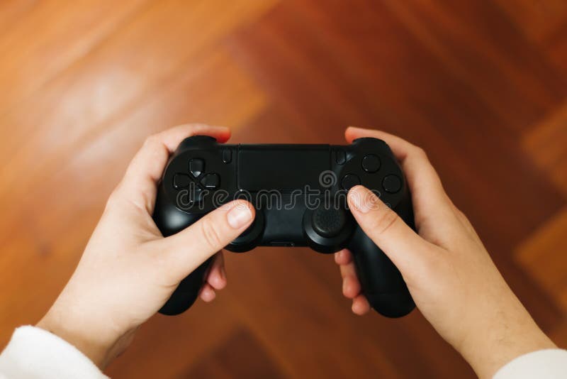 Selective Focus on the Hands of a Woman with a Game Controller Playing ...