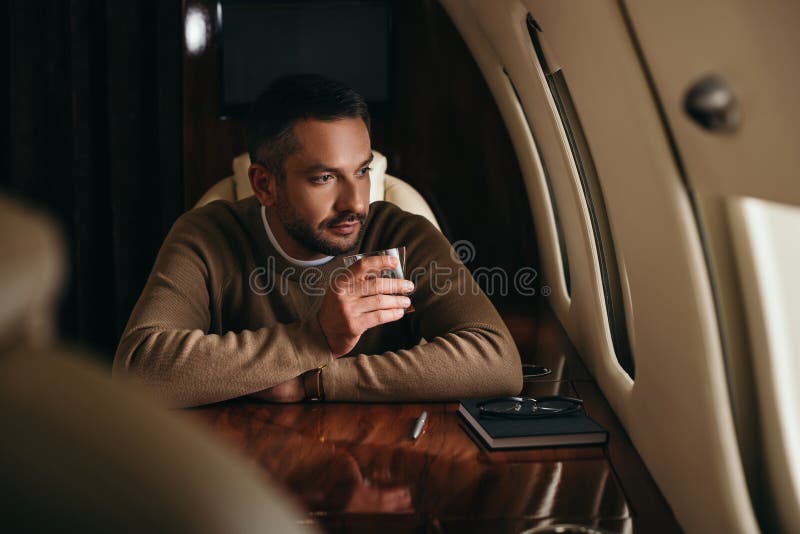 Focus of Handsome Bearded Man Holding Glass with Alcohol Drink while ...