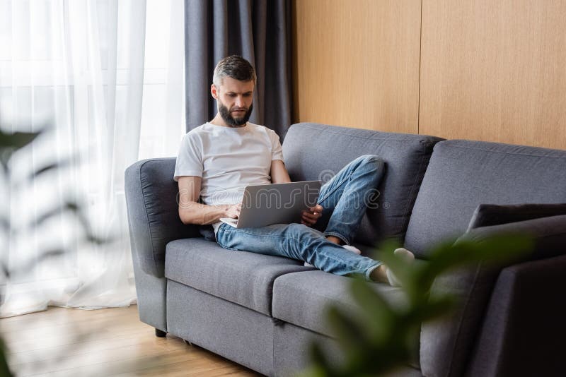 Selective Focus of Handsome Teleworker Using Laptop while Sitting on ...