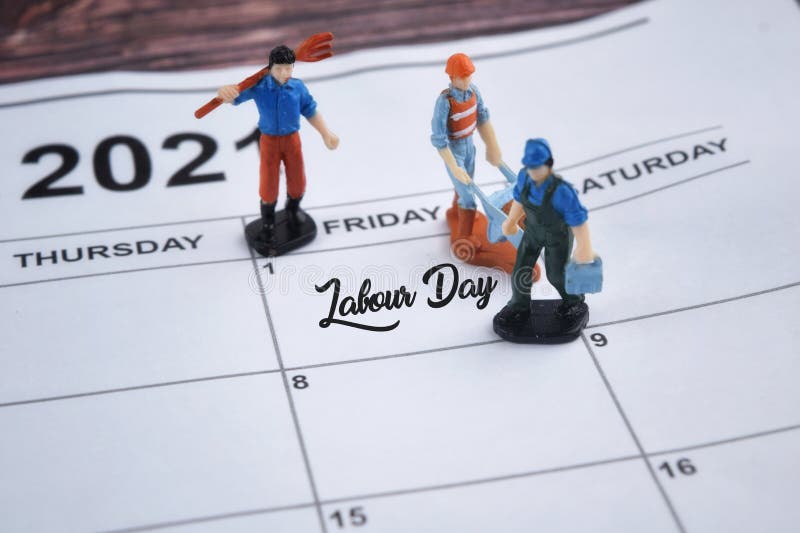 Selective Focus Image of Human Miniature on a Calendar with Labour Day ...