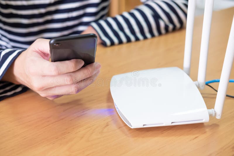 Selective Focus at Internet Router with Man Using Smart Phone Device To ...