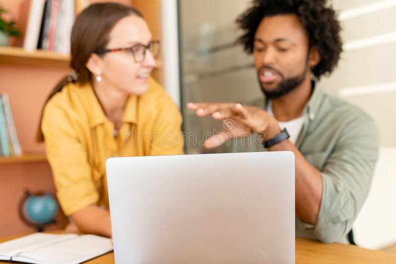 Selective Focus at the Laptop, Two Colleagues Have Discussion ...