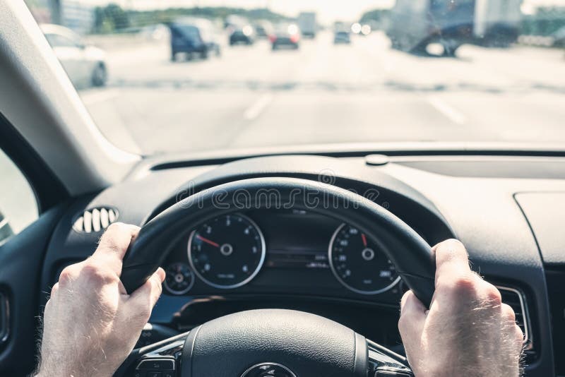 Selective Focus of Man Hands on Steering Wheel Driving a Car on the ...
