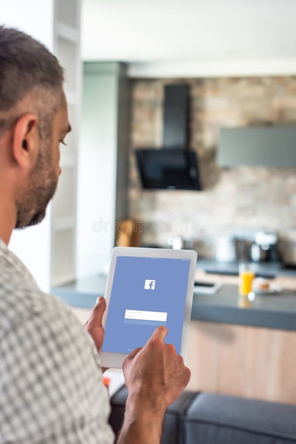 Selective Focus of Man Using Digital Tablet with Facebook Logo on ...