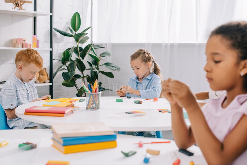 Selective Focus of Multiracial Kids with Plasticine at Tables Stock ...