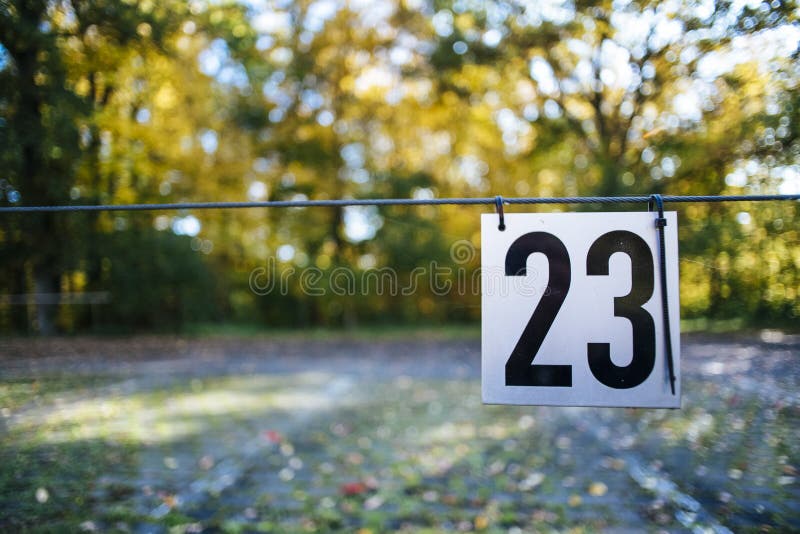 Selective Focus of the Number "23 " Sign Hanging from a Metallic Wire ...