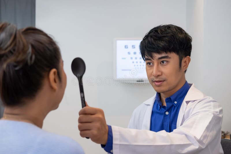 Selective Focus at Optometrist Face. while Doctor Using Penlight and ...