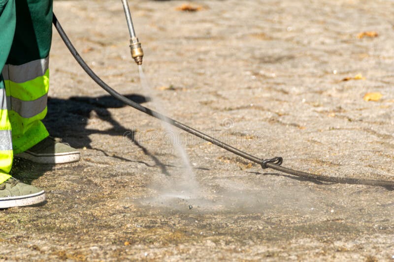 Selective Focus, a Public Cleaning Worker Cleaning the Street with ...