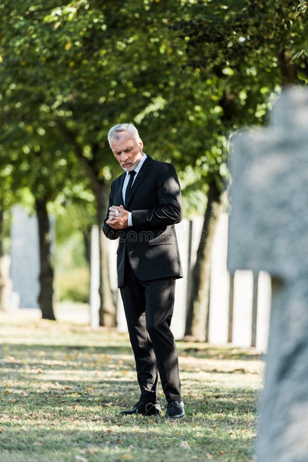 Focus of Sad Elderly Man Standing on Graveyard Stock Photo - Image of ...