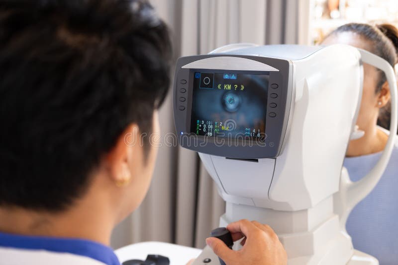Selective Focus at Screen of Optometry Equipment. while Optometrist ...