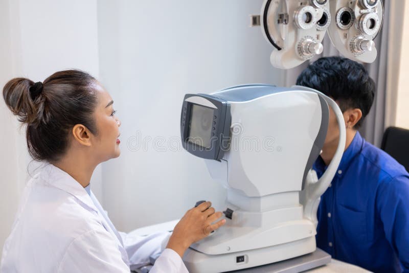 Selective Focus at Screen of Optometry Equipment. while Optometrist ...