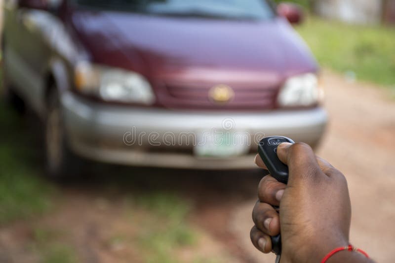 Selective Focus Shot of a Black Person Using a Car Remote To Unlock a ...
