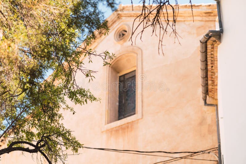 Selective Focus Shot of the Facade of a Building with the Tree Branches ...
