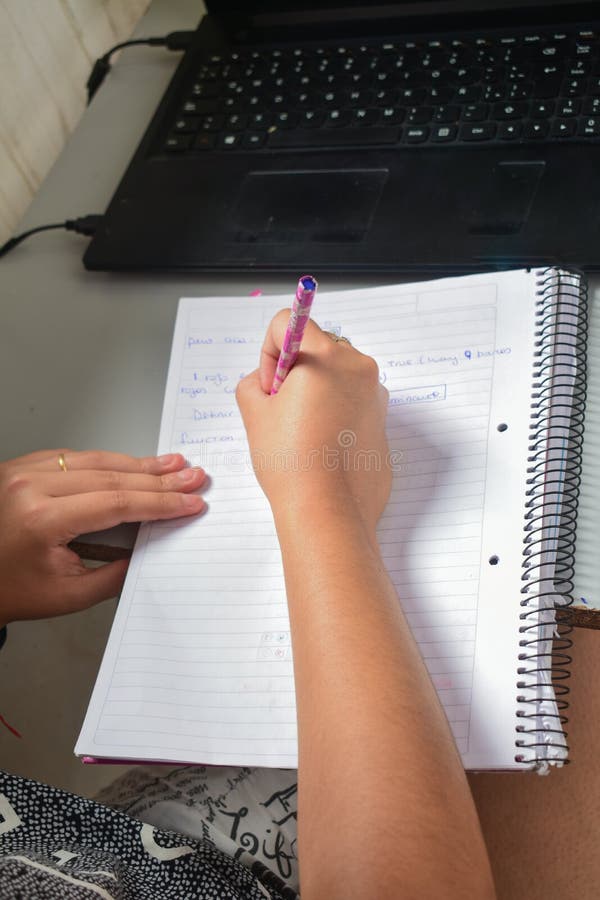 Selective Focus Shot of Female Writing Some Notes in a Notebook from a ...