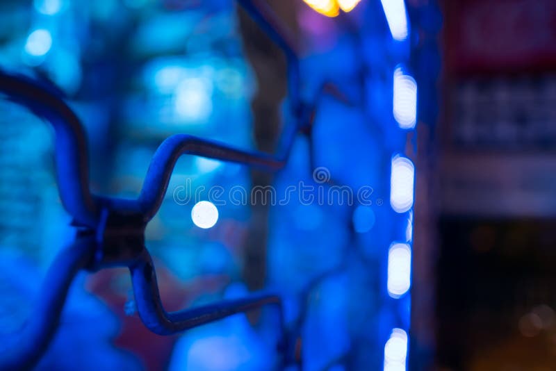 Selective Focus Shot of Gate Bars Shaping Patterns and Blue Lights ...