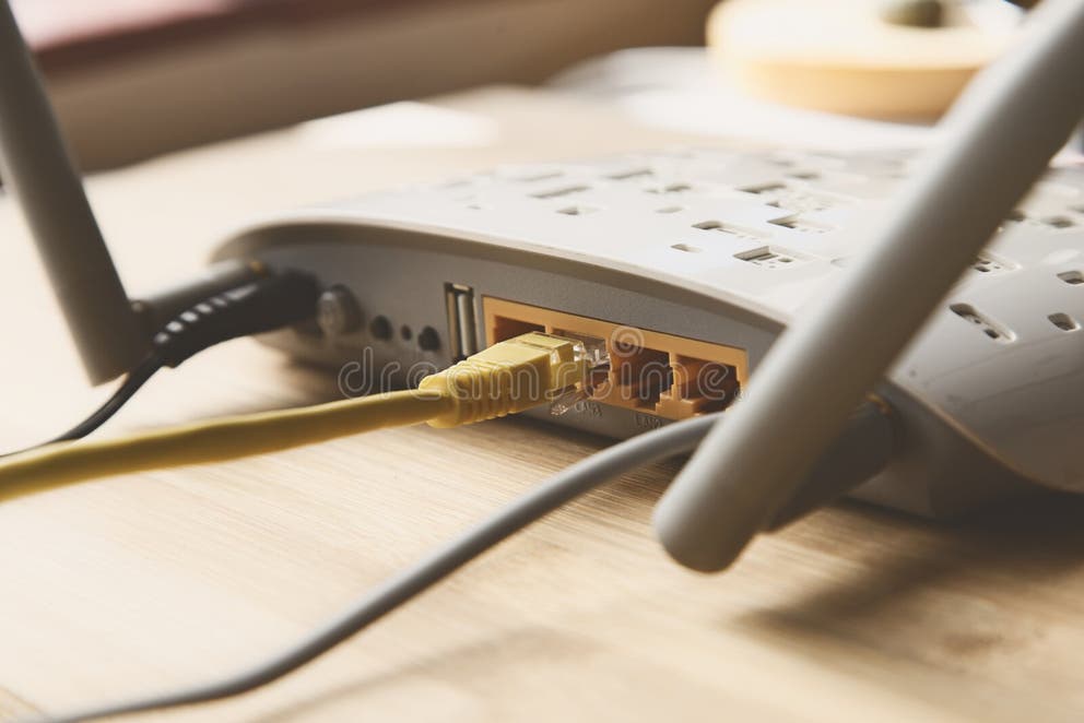 Selective Focus Shot of an Internet Modem with a Yellow Cable on a ...