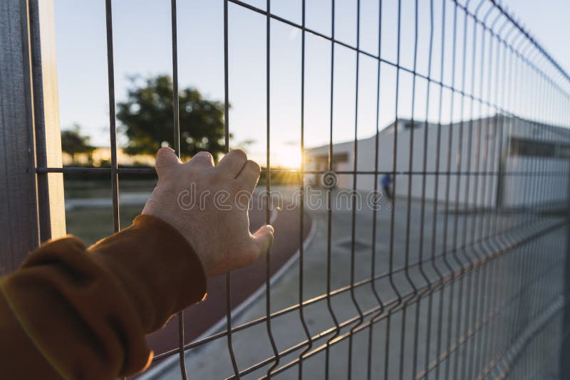 Selective Focus Shot of a Male S Hand Touching Metallic Bars Stock ...