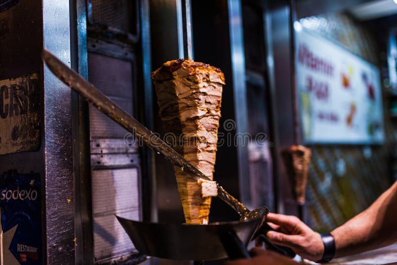Selective Focus Shot of a Person Cutting the Shawarma Meat Stock Photo ...