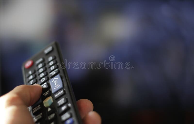Selective Focus Shot of a Person Pushing the Mute Button on the Remote ...