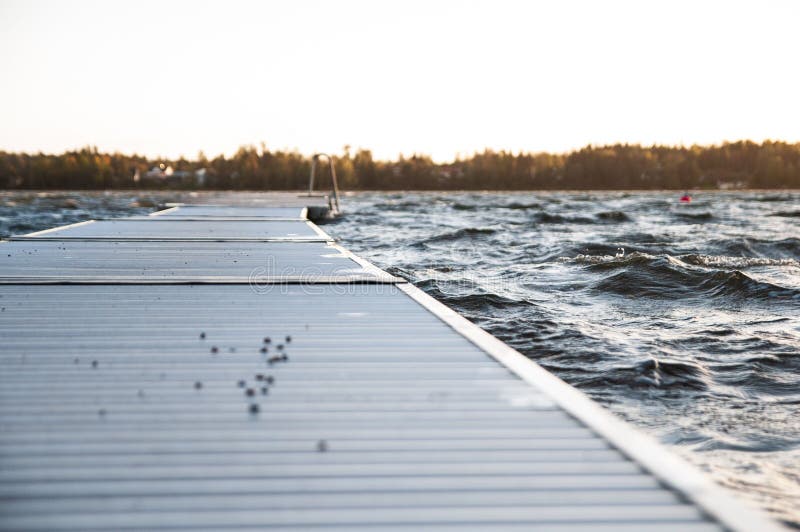 Selective Focus Shot of a Pier on a Wavy Lake Stock Image - Image of ...