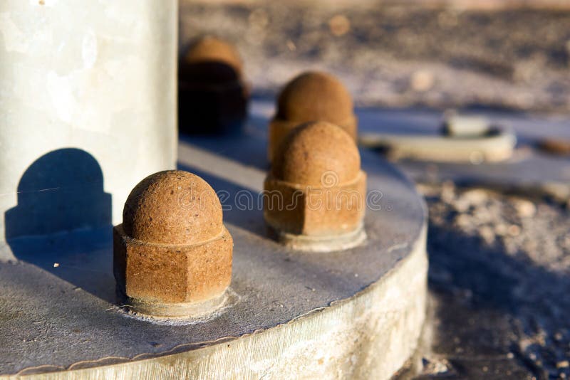 Selective Focus Shot of Rusty Metal Nuts Holding a Concrete Post on the ...