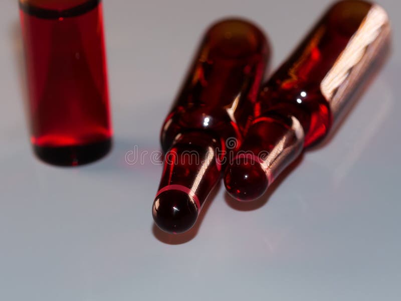 Selective Focus Shot of Three Red Ampoules Isolated on a White ...