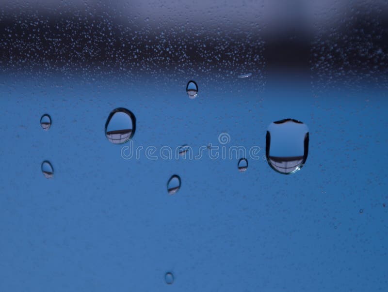 Selective Focus Shot of the Waterdrops Sliding Down through a Window ...