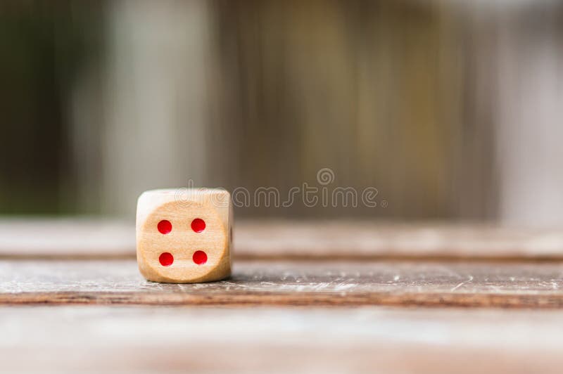 Selective Focus Shot of a Wooden Die with Four Red Spots Stock Photo ...