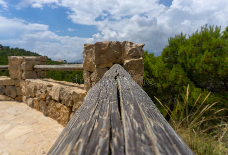 Selective Focus Shot of a Wooden Railing Connected To a Brick Post ...