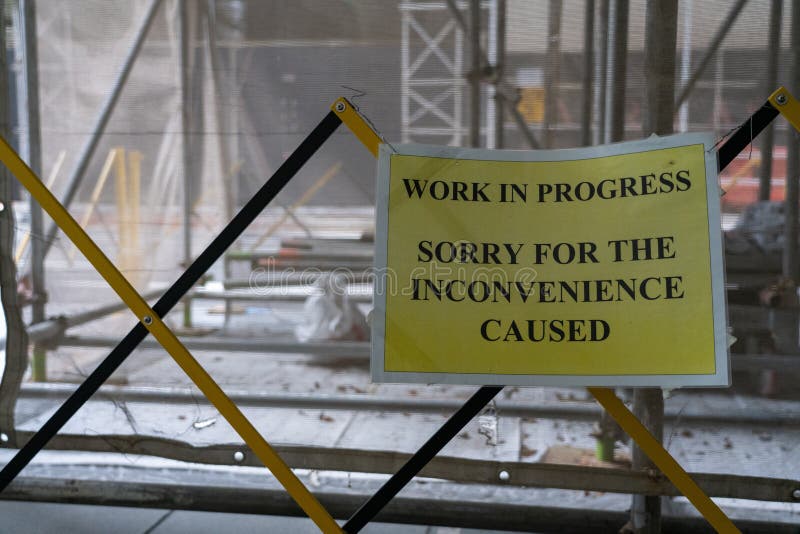 Selective Focus Shot of a Yellow Poster with Work in Progress Massage ...