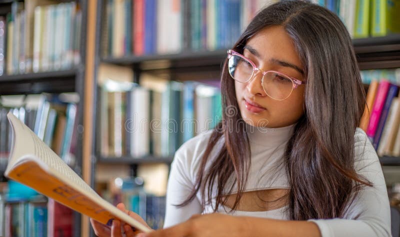 Selective Focus Shot of a Young Female from Colombia Reading a Book in ...