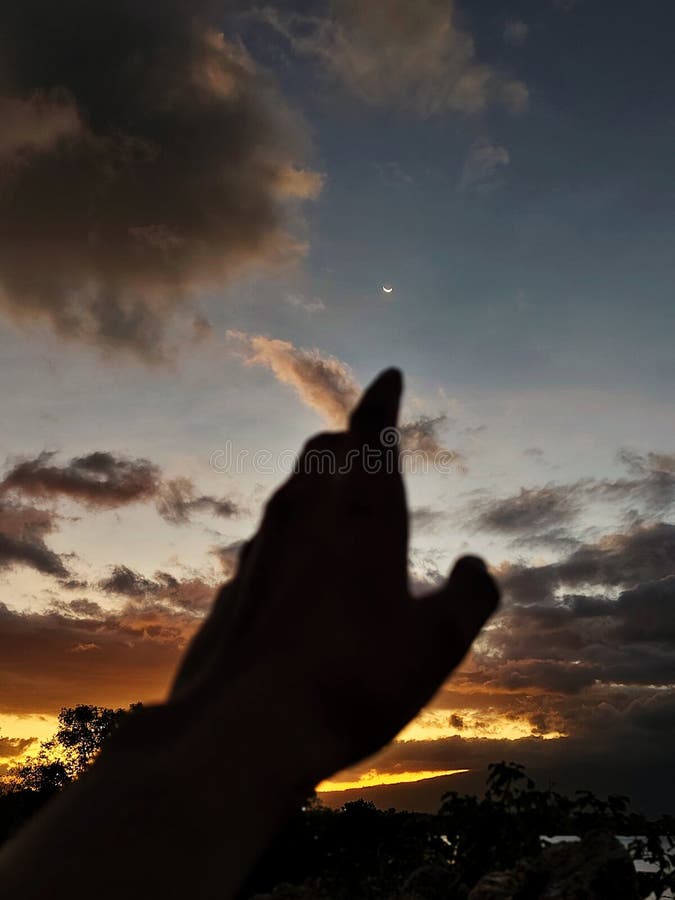 Selective Focus and Silhouette of a Man S Left Hand Reaching Out for ...